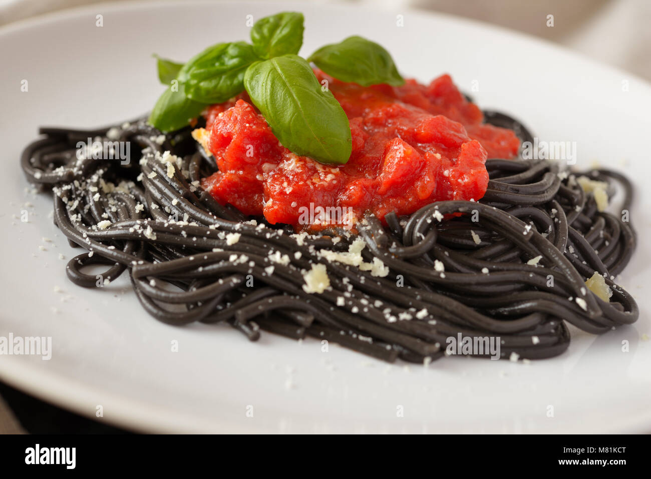 Cuttlefish ink spaghetti with Parmesan cheese and tomato sauce ...