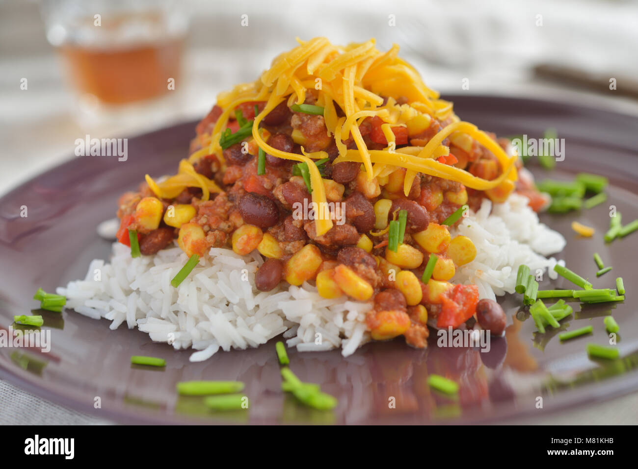 Chili con carne with rice and chives Stock Photo - Alamy