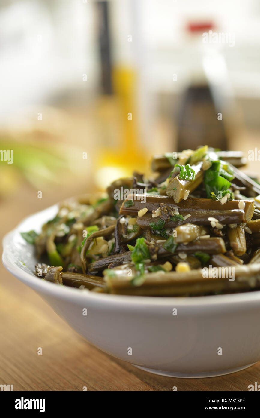 Sauteed bracken fern with sesame oil and seeds Stock Photo - Alamy