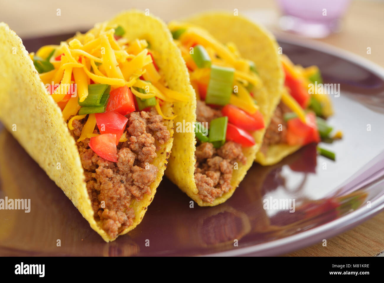 Tacos with ground beef, Cheddar cheese, and vegetables Stock Photo - Alamy