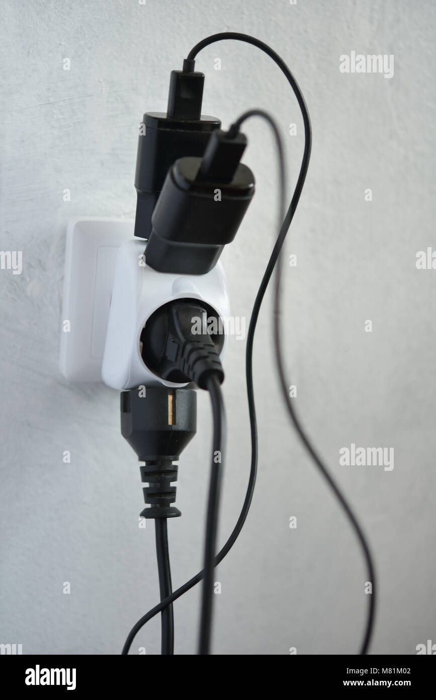 Power outlet with four plugs Stock Photo - Alamy