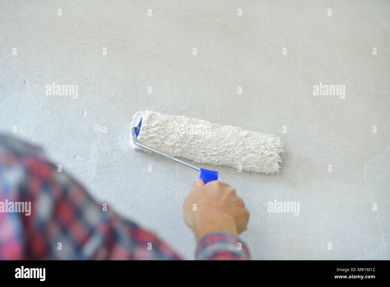 Man using roller paint white hi-res stock photography and images - Alamy