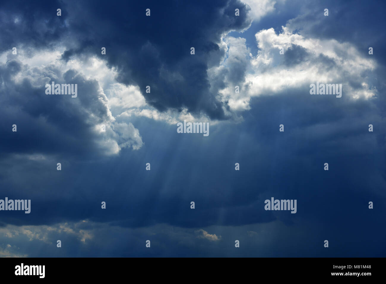 Sun beams coming through clouds Stock Photo - Alamy