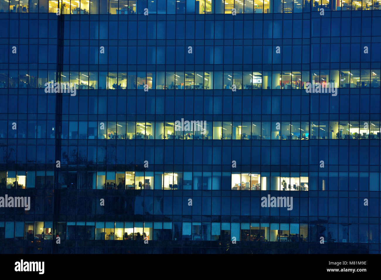 Background image of modern office building in the night Stock Photo - Alamy