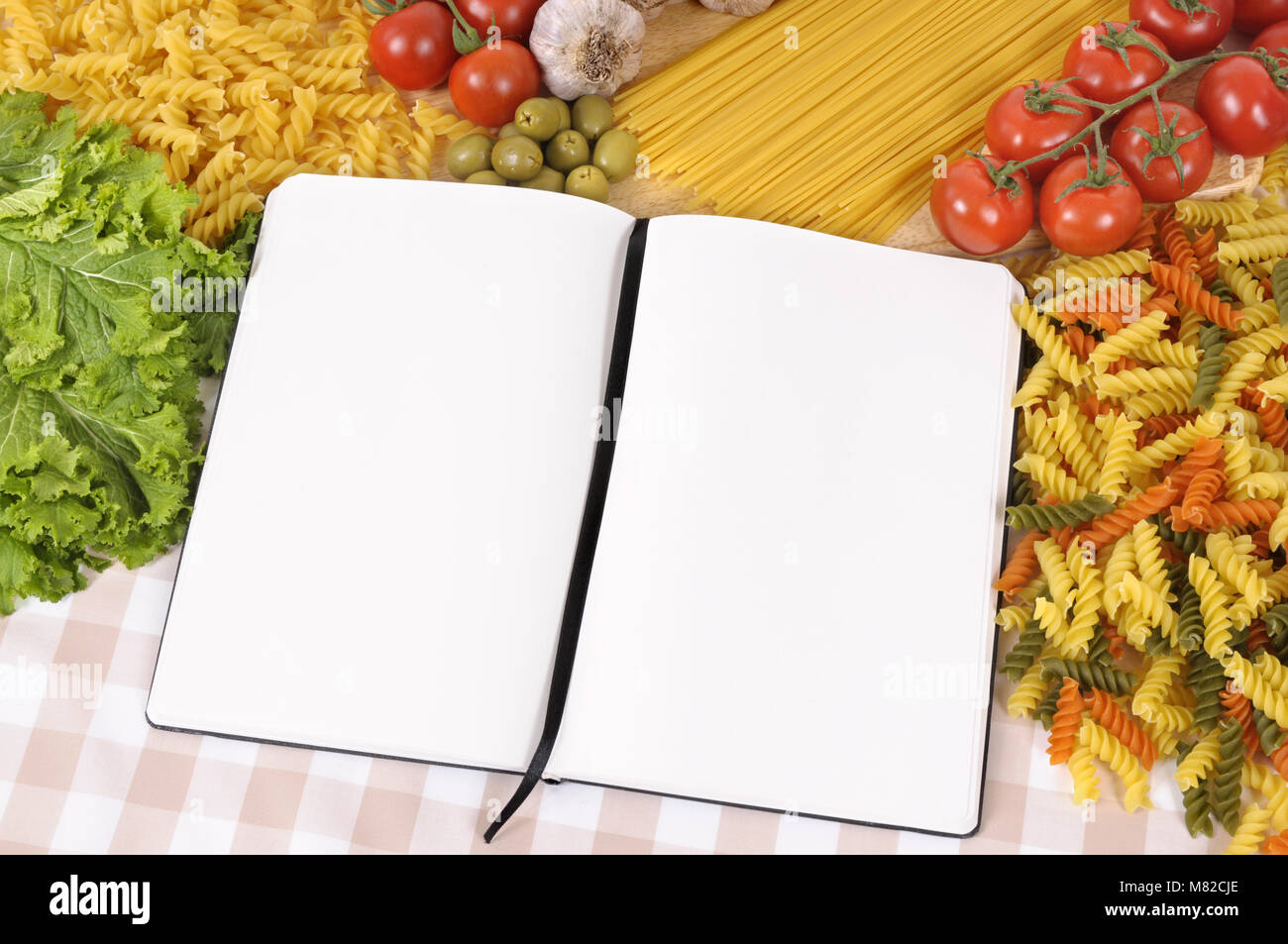 Selection of Italian spaghetti and pasta with blank recipe book or ...