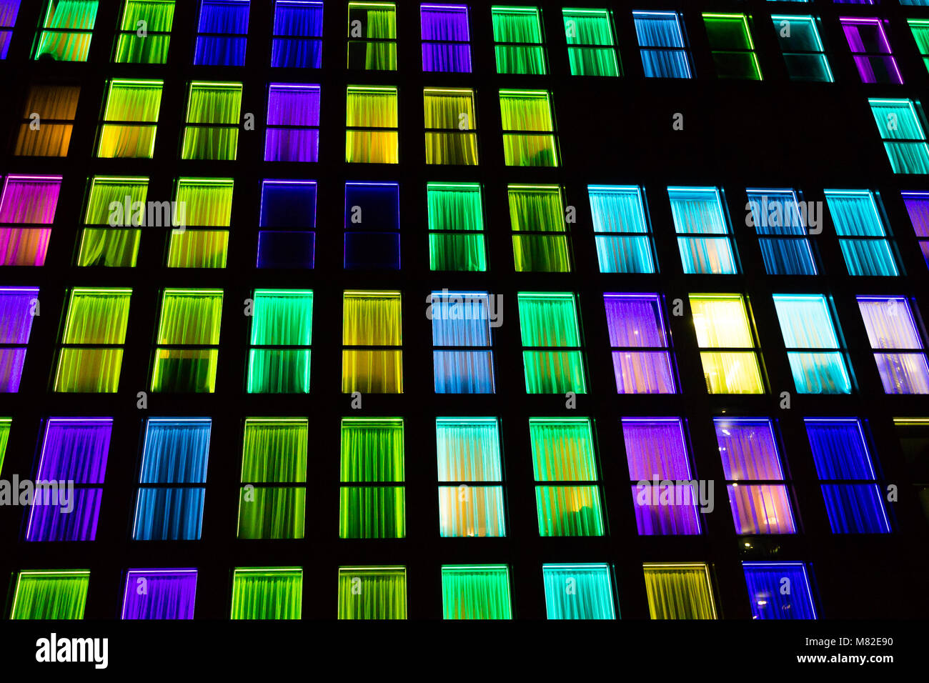 Colored windows texture. Windows illuminated by neon lights background ...
