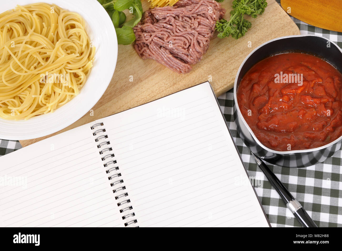 Making Italian spaghetti bolognese with ingredients and blank recipe ...