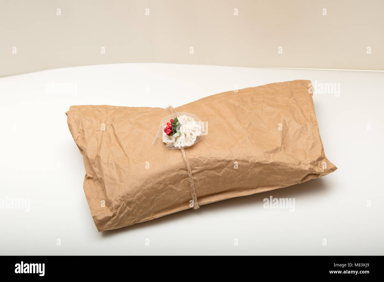 Gift in crumpled recycle brown recycle paper tied with string and ...