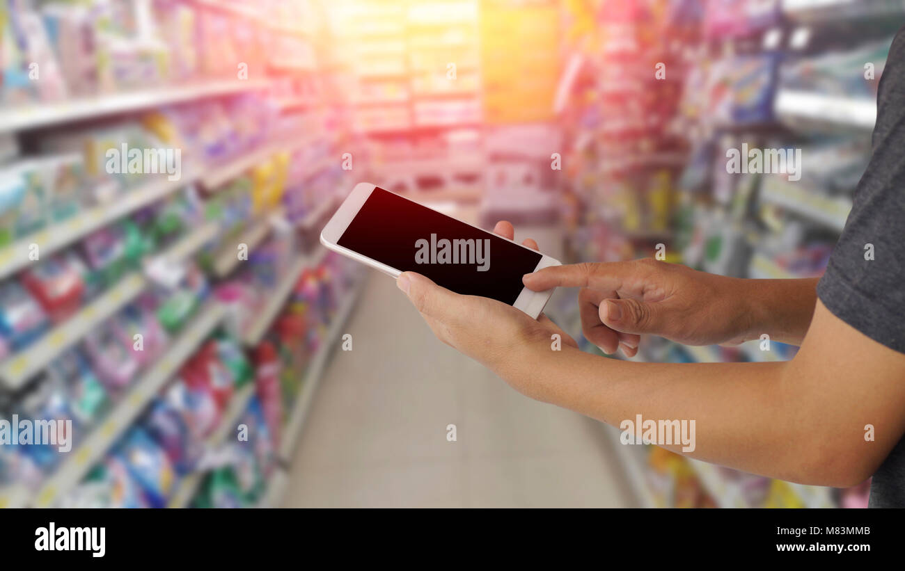 Hands using blank screen mobile smart phone with blurred background in ...