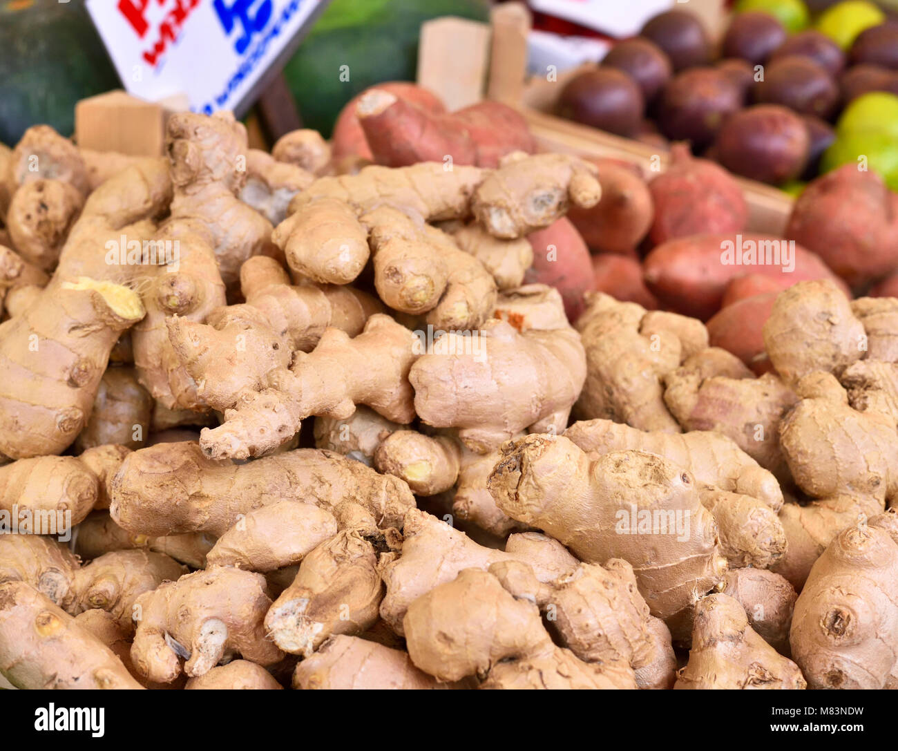 fresh raw ginger on a street market stall. Heap or stack of fresh ...