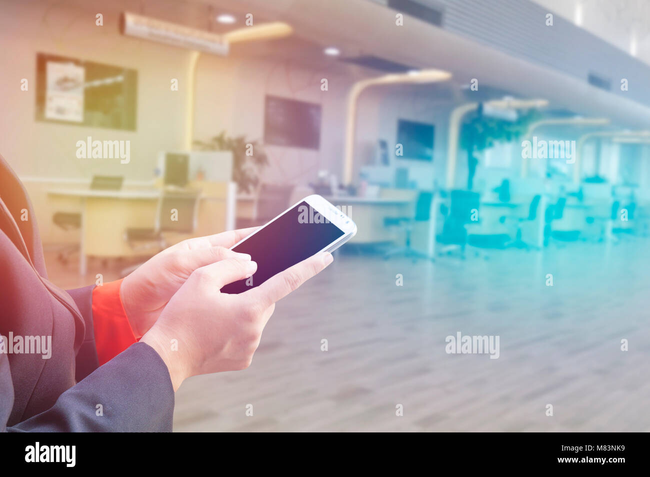 Hands using blank screen mobile smart phone with blurred background in ...