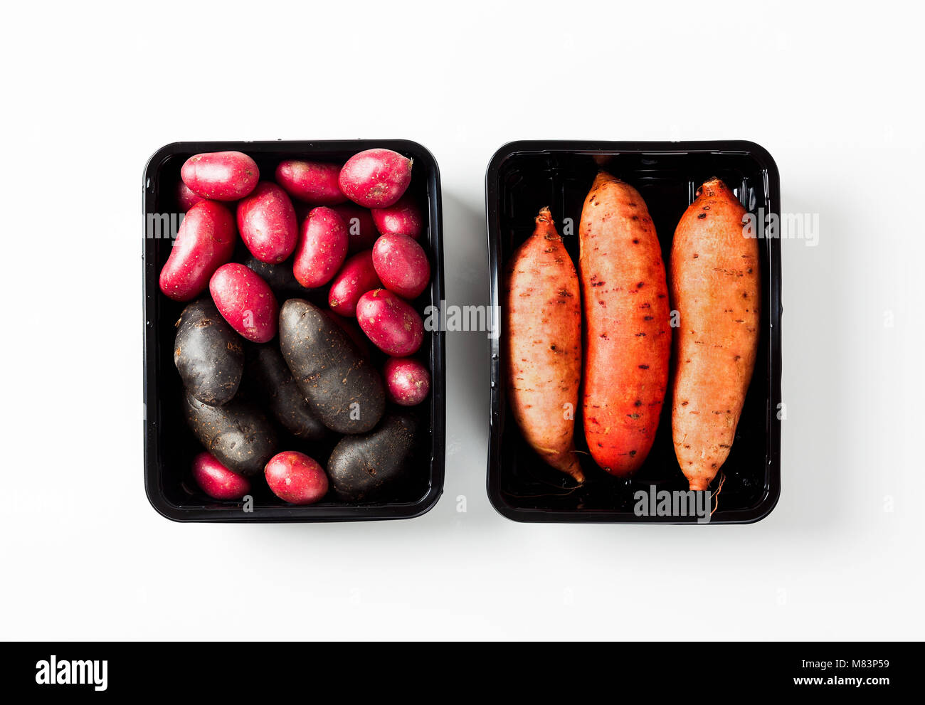 Different varieties in form and color of potatoes on a white isolated ...