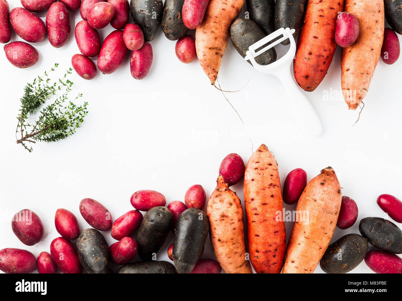 Different varieties in form and color of potatoes on a white isolated ...