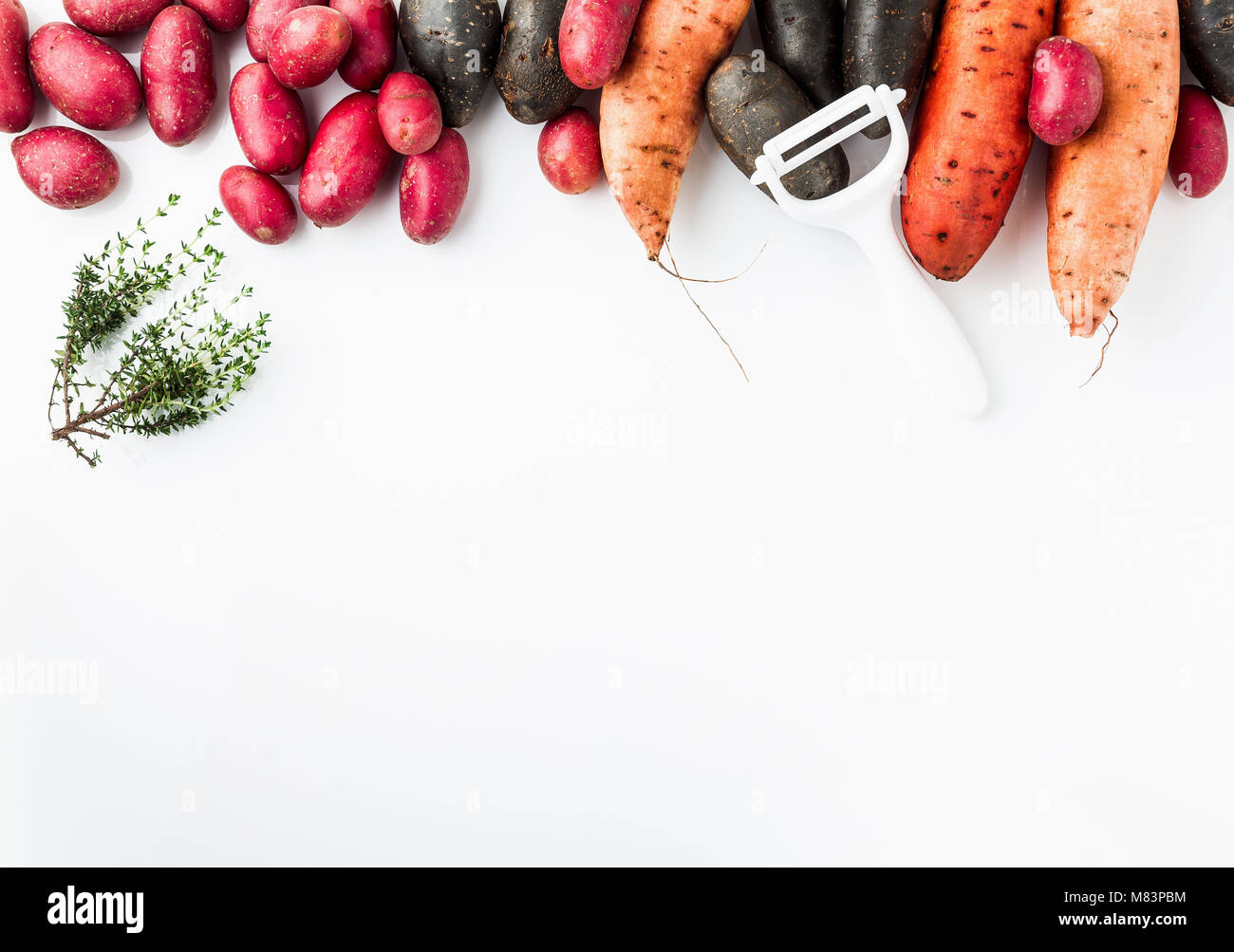 Different varieties in form and color of potatoes on a white isolated ...