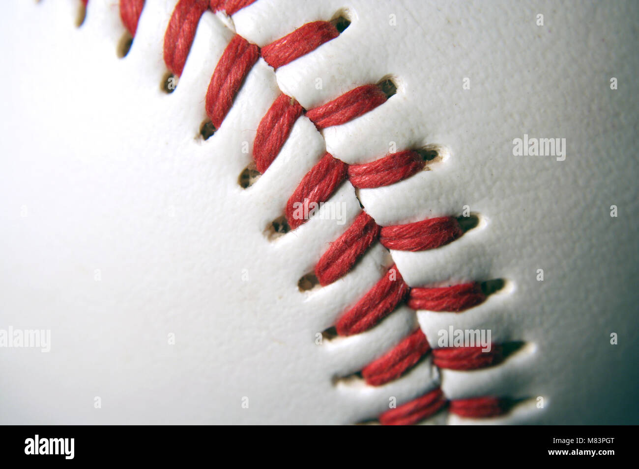 A white Baseball Macro with red stitching Stock Photo - Alamy