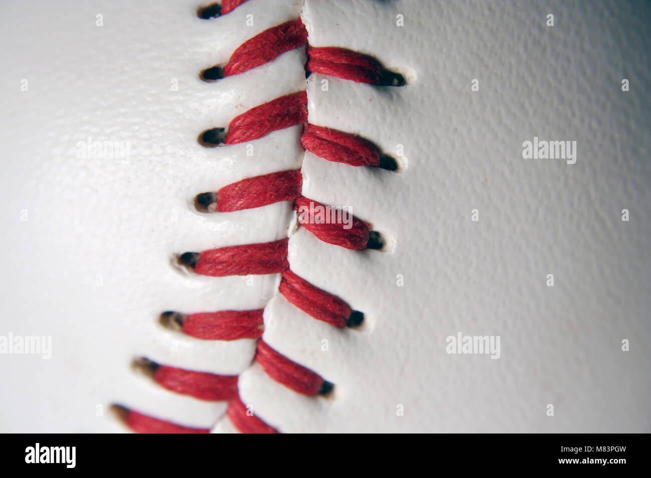 A white Baseball Macro with red stitching Stock Photo - Alamy