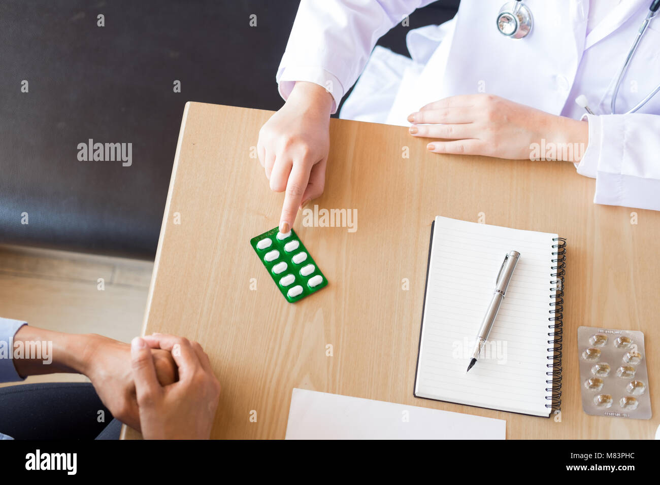 doctor hand holding tablet of drug and explain to patient in hospital ...
