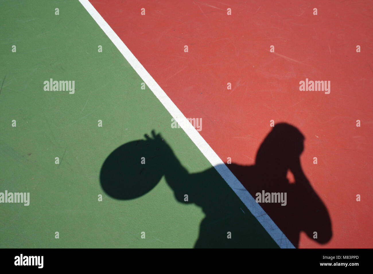 A Basketball shadow player dribbling on red and green court Stock Photo ...