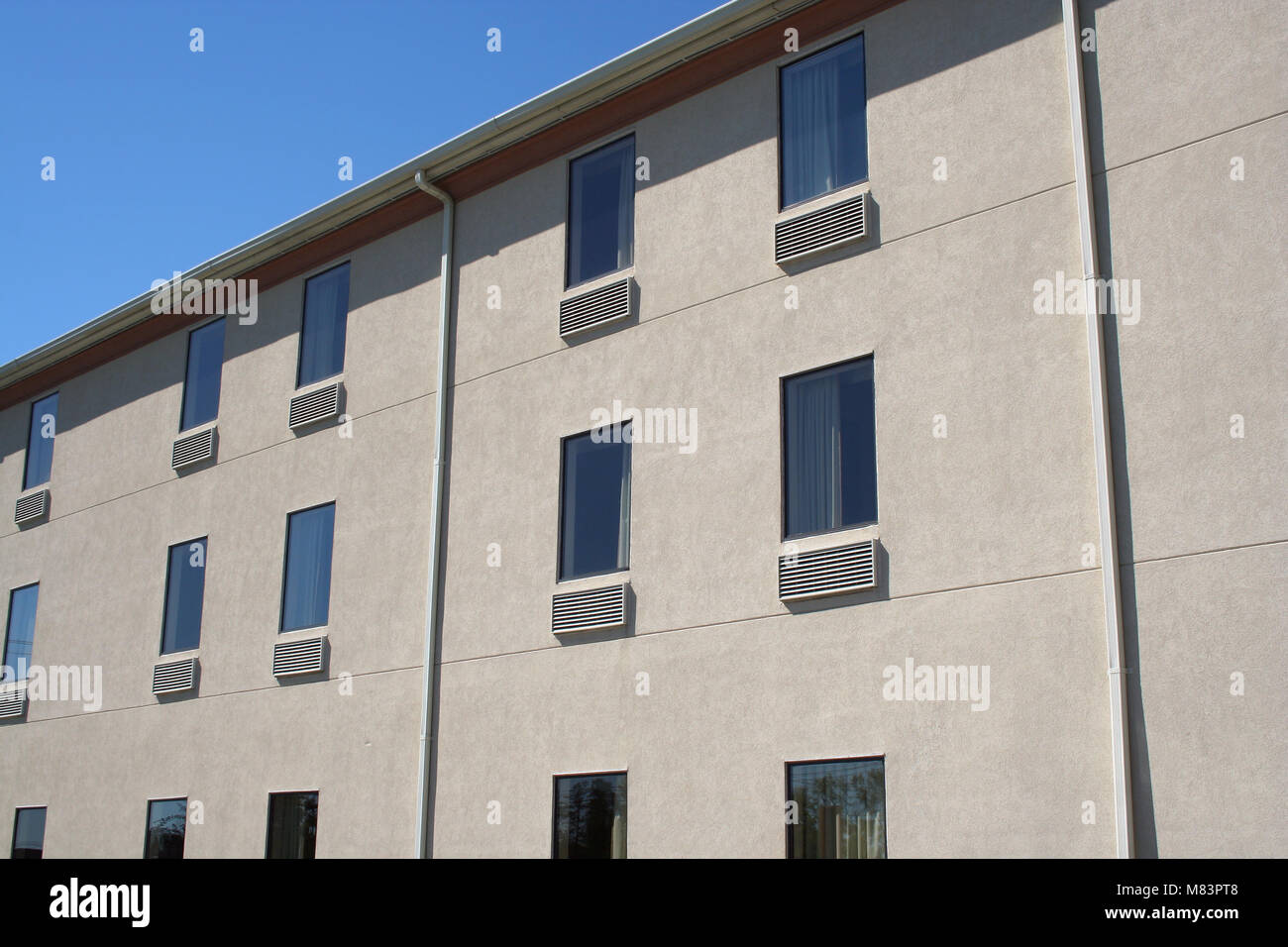 An exterior view of a hotel with windows Stock Photo - Alamy