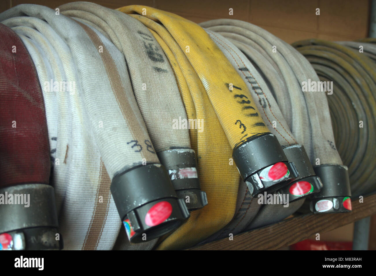 Fire Hoses lined up inside a firehouse Stock Photo - Alamy