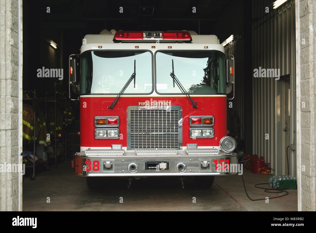 A Fire Truck parked inside a firehouse Stock Photo - Alamy