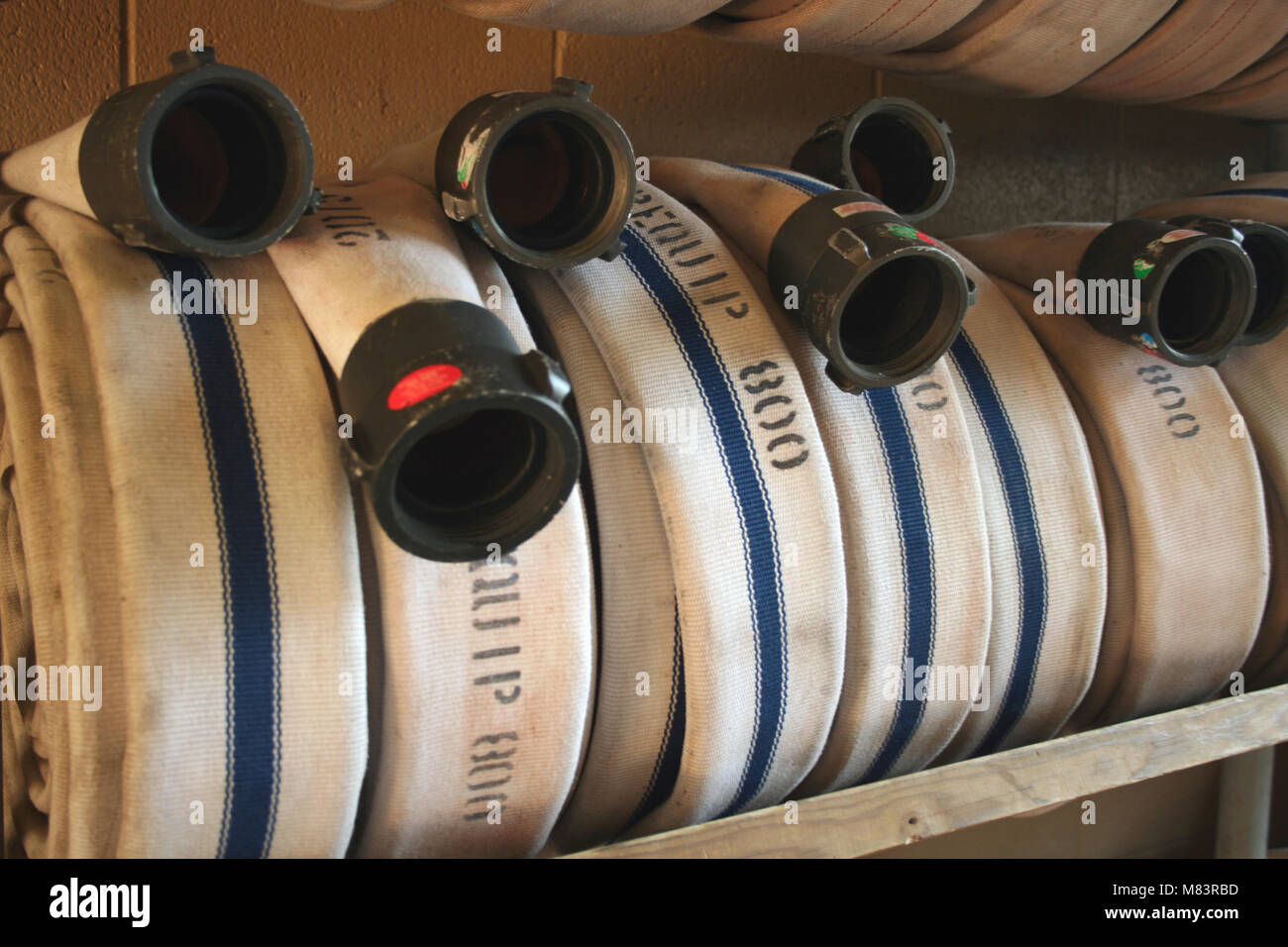 Fire Hoses lined up inside a firehouse Stock Photo - Alamy
