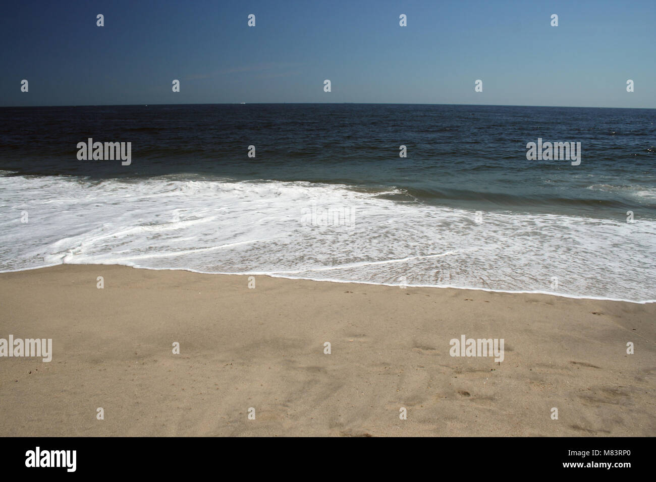 Shoreline at the beach with sand and water Stock Photo - Alamy
