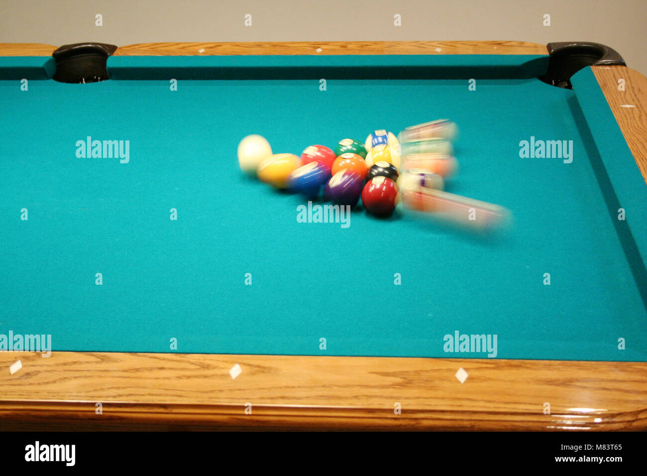 8 ball being broken on green pool table Stock Photo - Alamy