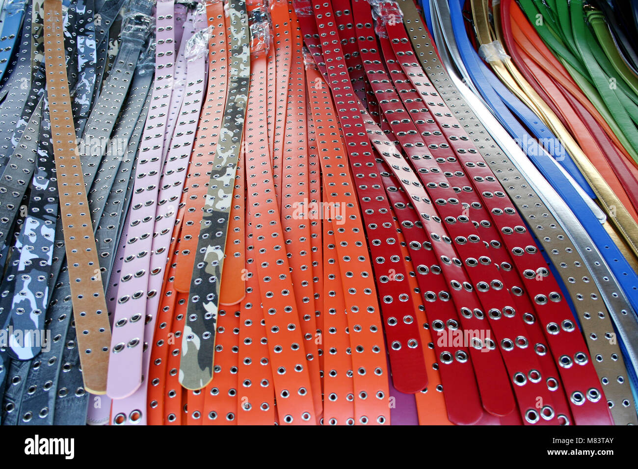 a bunch of belts at a flea market Stock Photo - Alamy