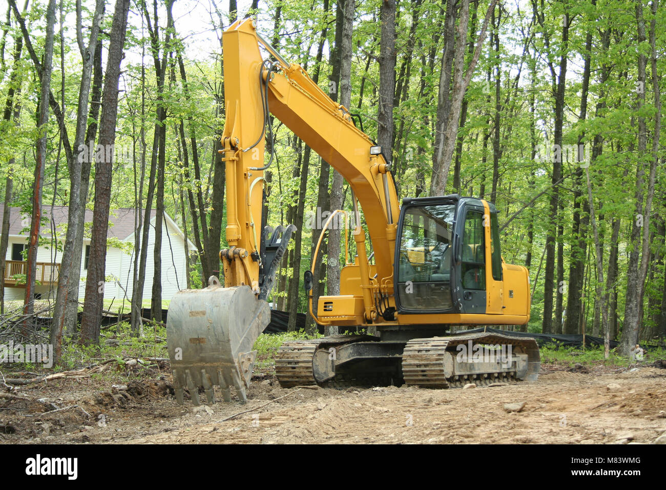 an image of a backhoe in the woods Stock Photo - Alamy