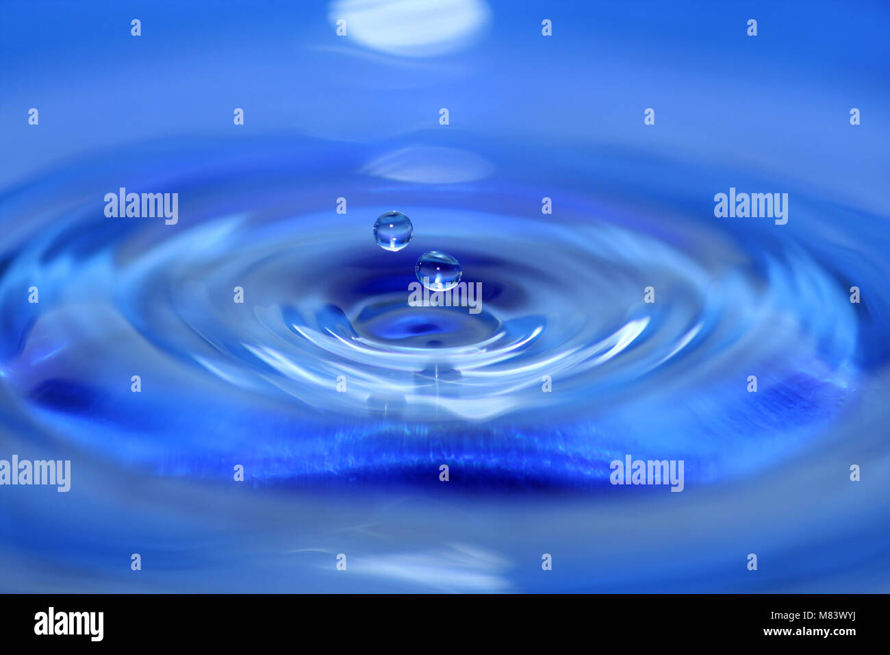 A two Blue water droplets falling Stock Photo - Alamy