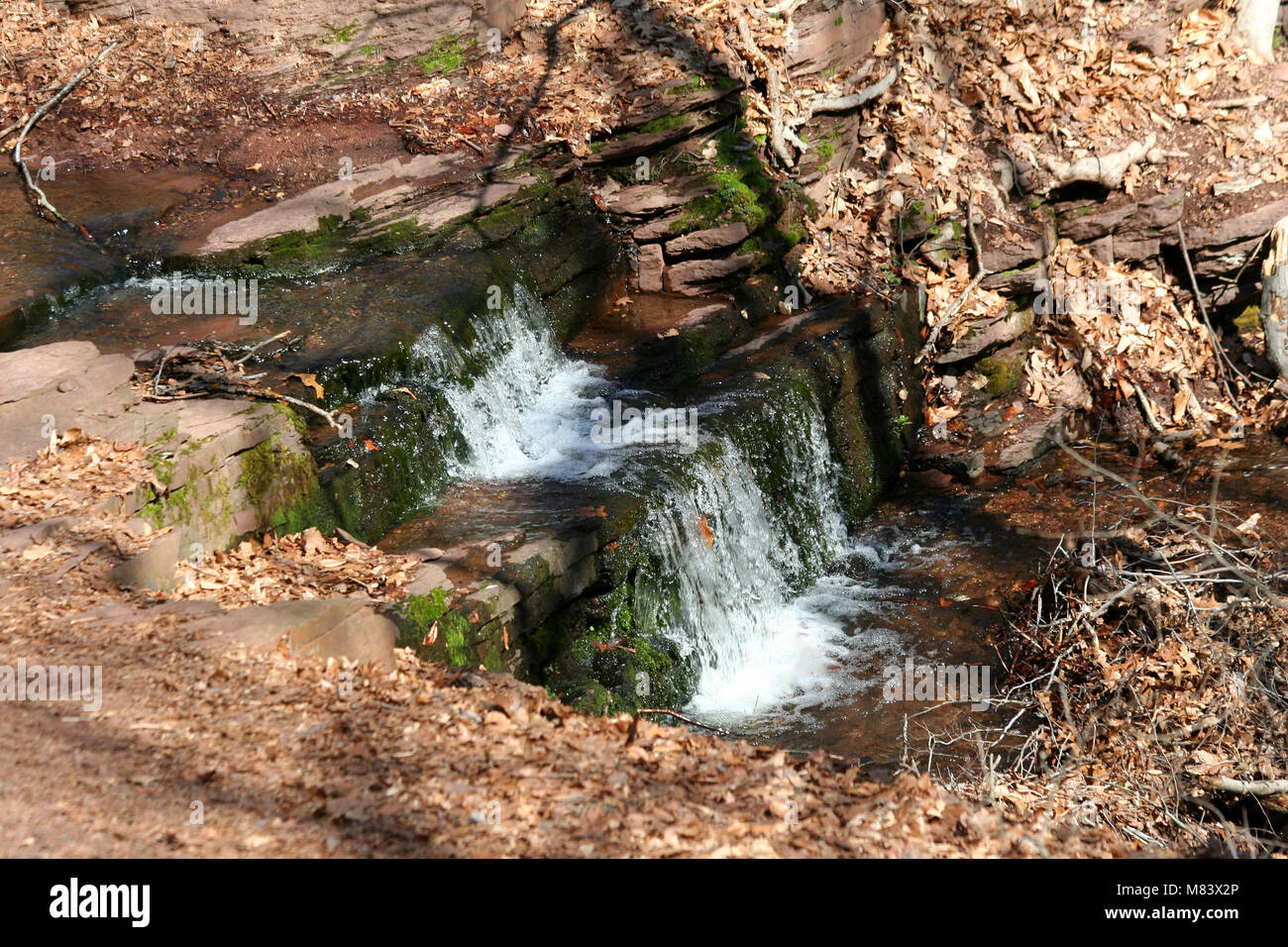 A small water fall in a stream Stock Photo - Alamy