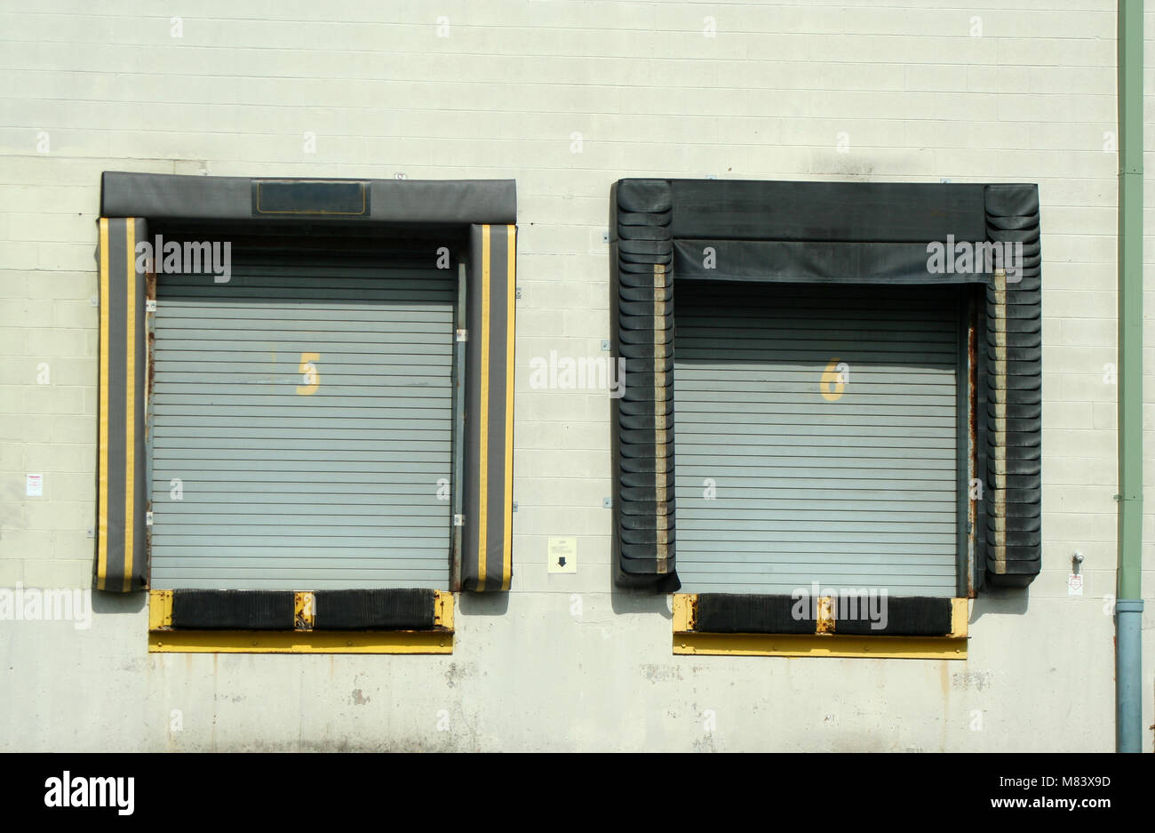 Two Loading dock bay doors Stock Photo - Alamy