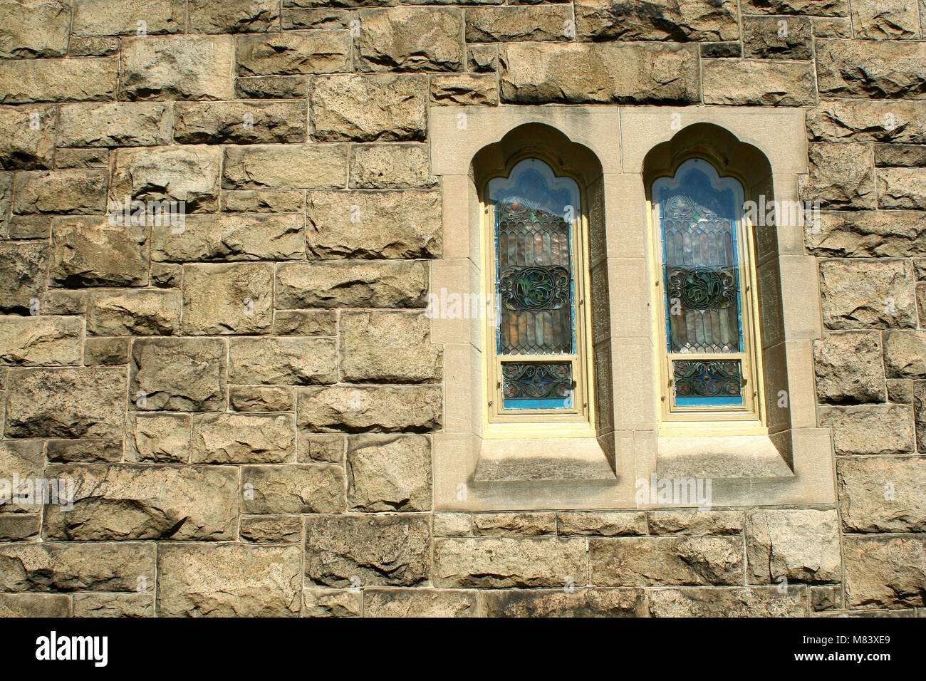 A Stone wall with stained glass windows Stock Photo - Alamy