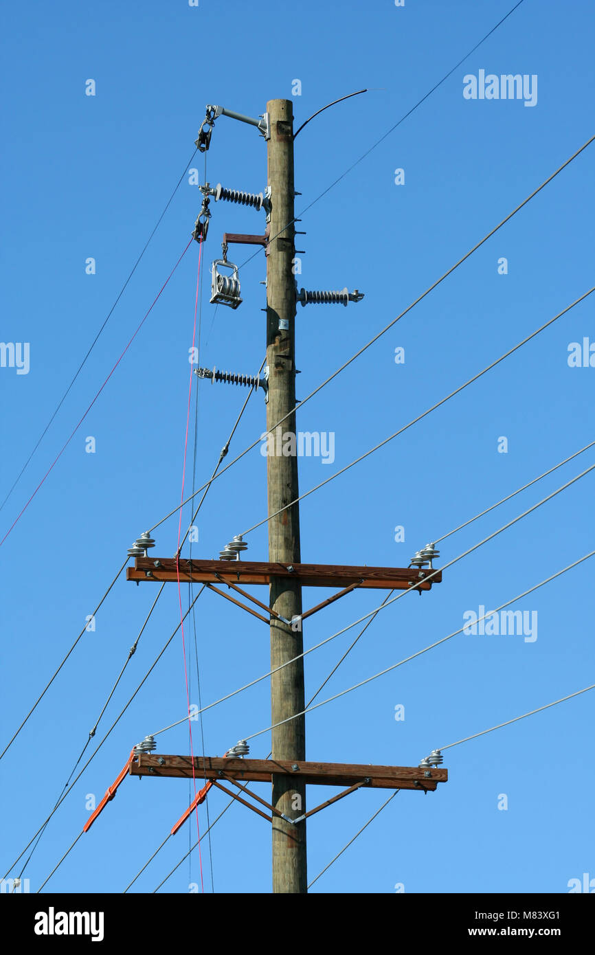 a telephone pole against blue sky Stock Photo - Alamy
