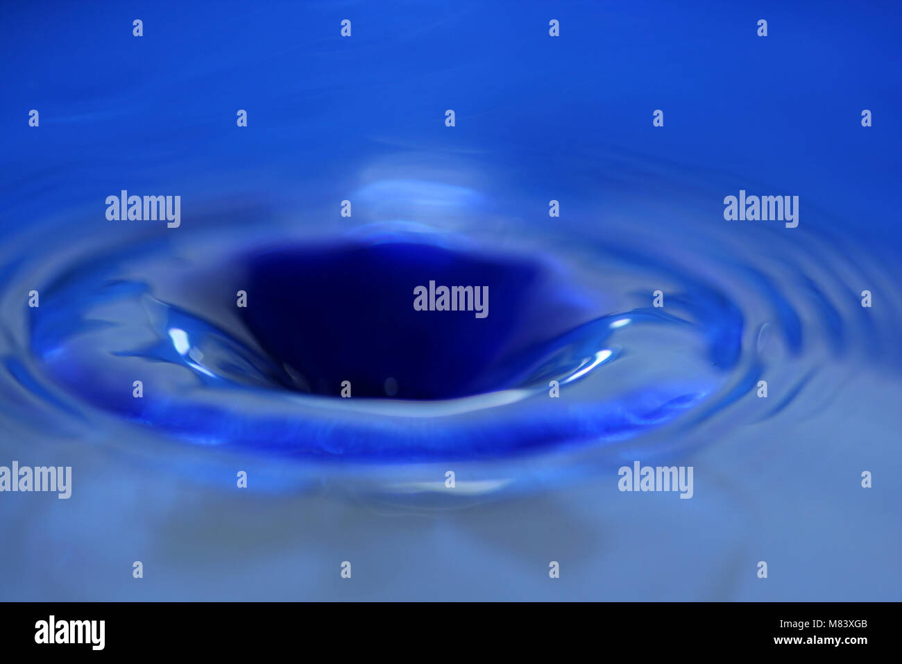 A hole in blue water Stock Photo - Alamy