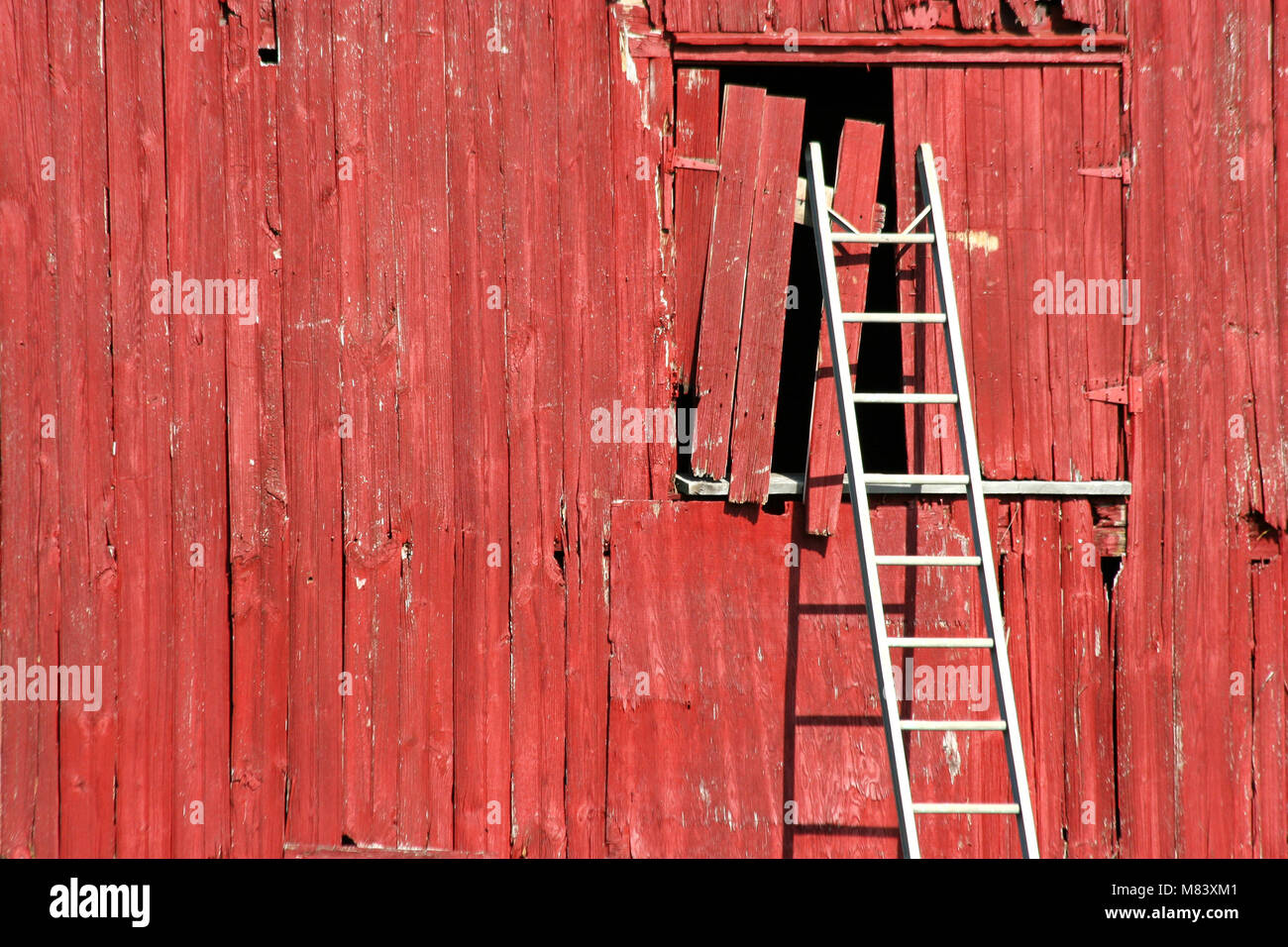 A ladder on a old red bard Stock Photo - Alamy