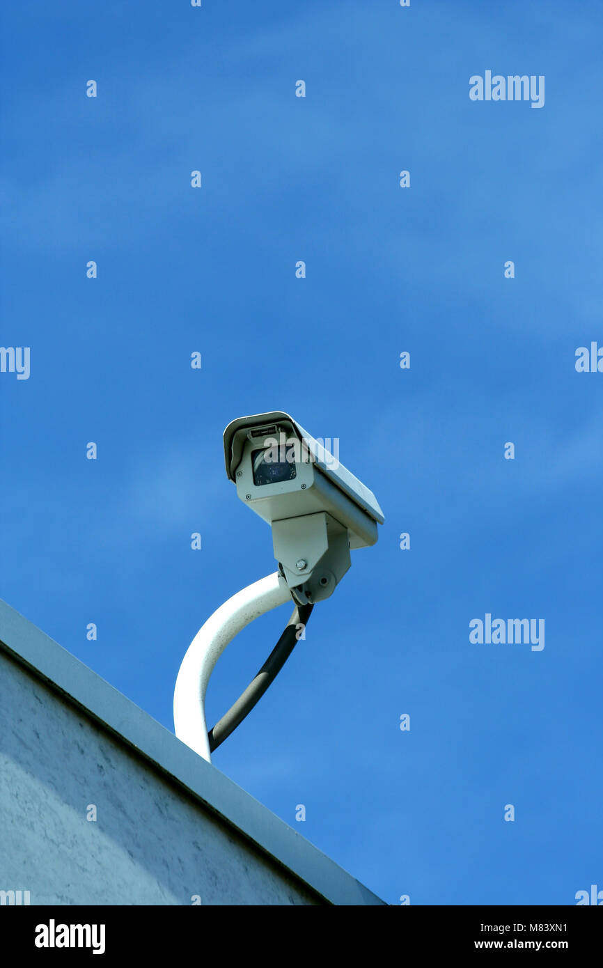 A Security camera against blue sky Stock Photo - Alamy
