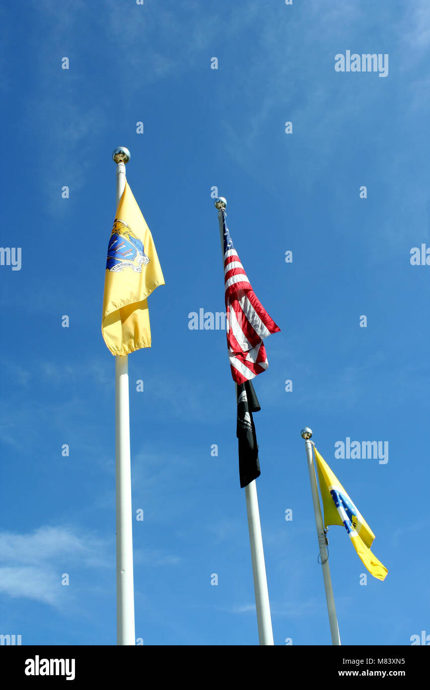 Three flags against blue sky with no wind Stock Photo - Alamy