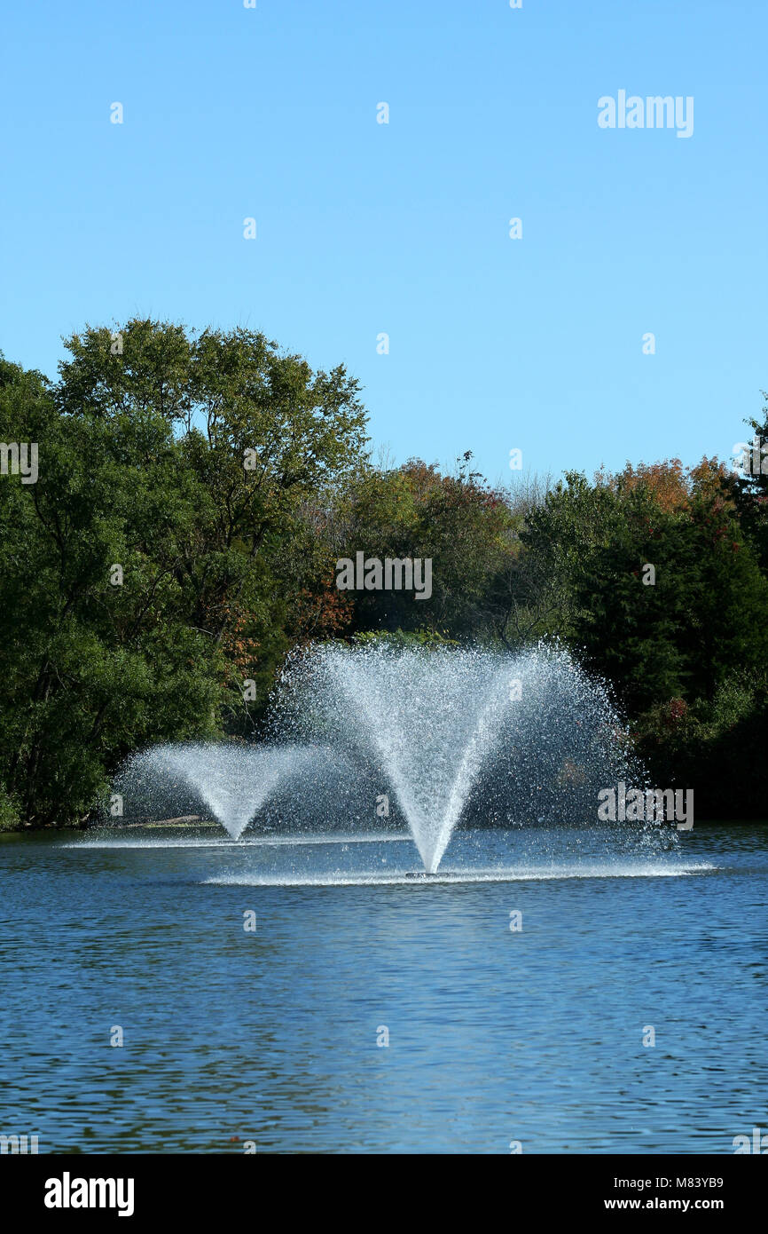 Two Fountains on a pond Stock Photo - Alamy