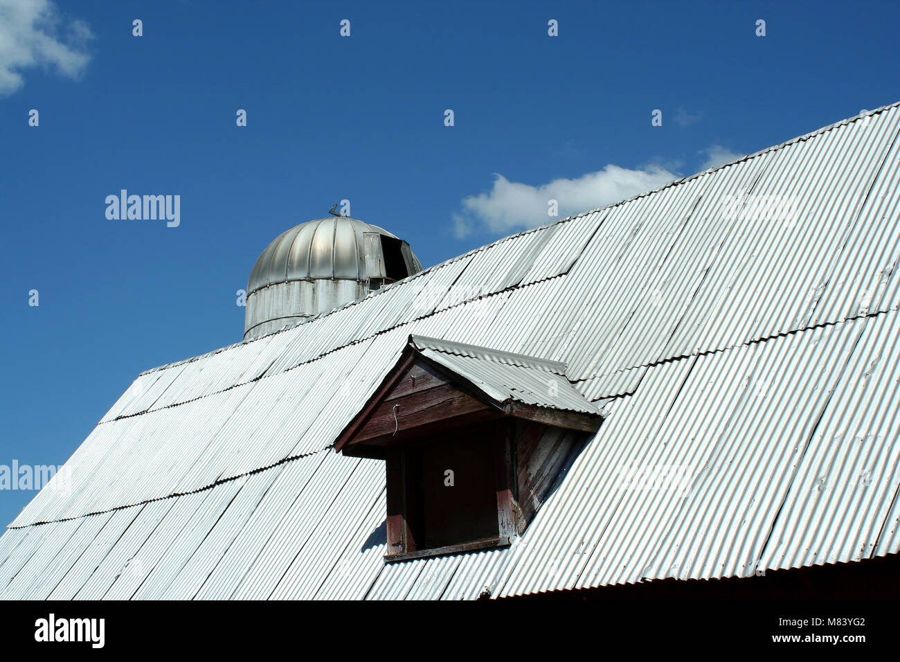 Barn window with silo against blue sky and clouds Stock Photo - Alamy