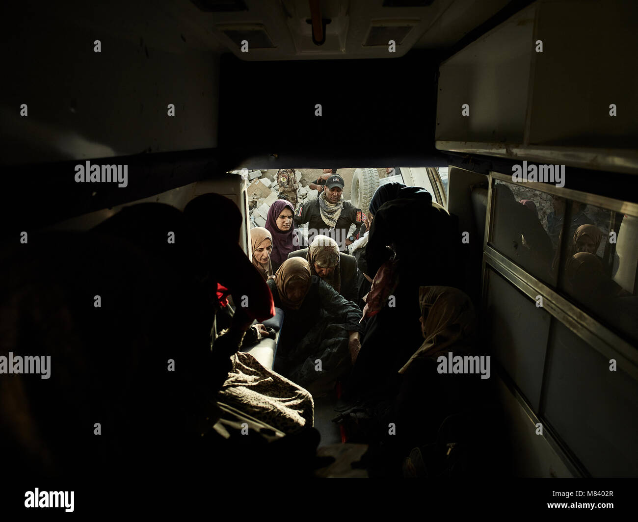 Rescued civilians board an ambulance near the Al-Nuri mosque. The city ...