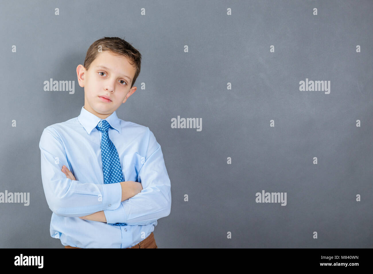 Confident boy student before dark background with copy-space as a ...