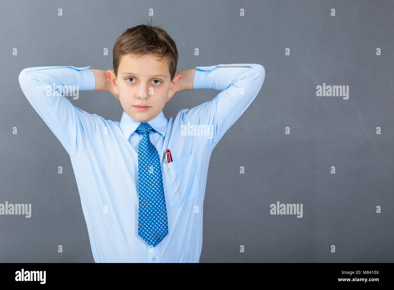 Confident boy student before dark background with copy-space as a ...