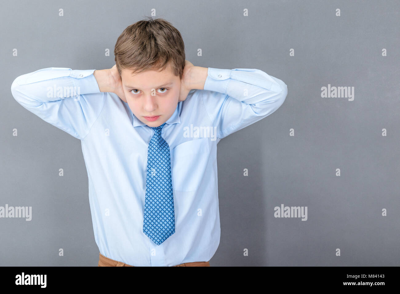 Boy under stress closes his ears Stock Photo - Alamy