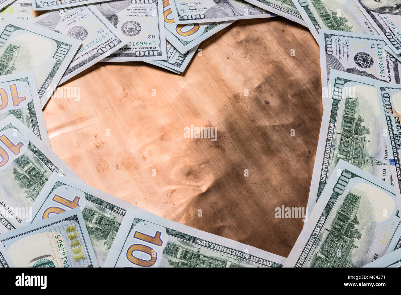 Copper bronze heart shape in center of dollar money background Stock ...