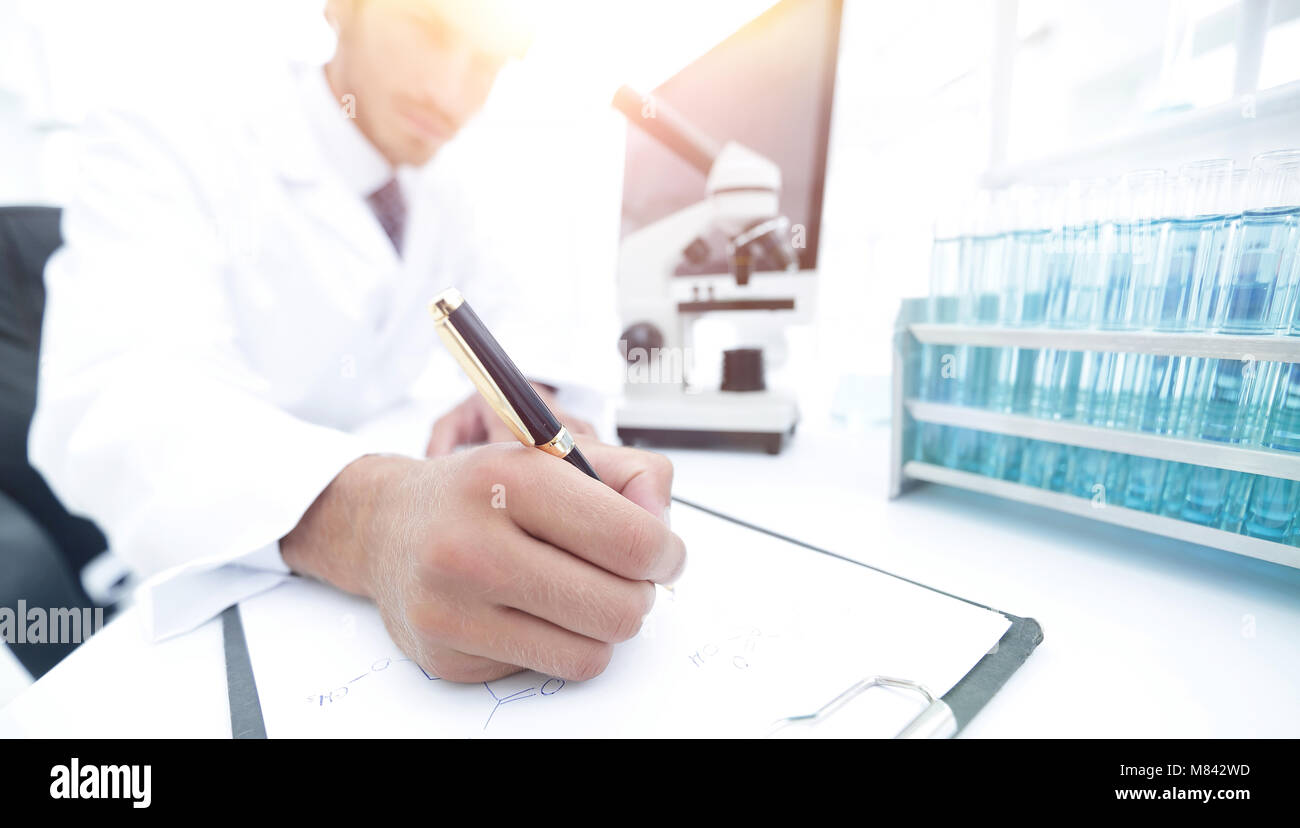 scientist makes a note of experiment in the laboratory Stock Photo - Alamy