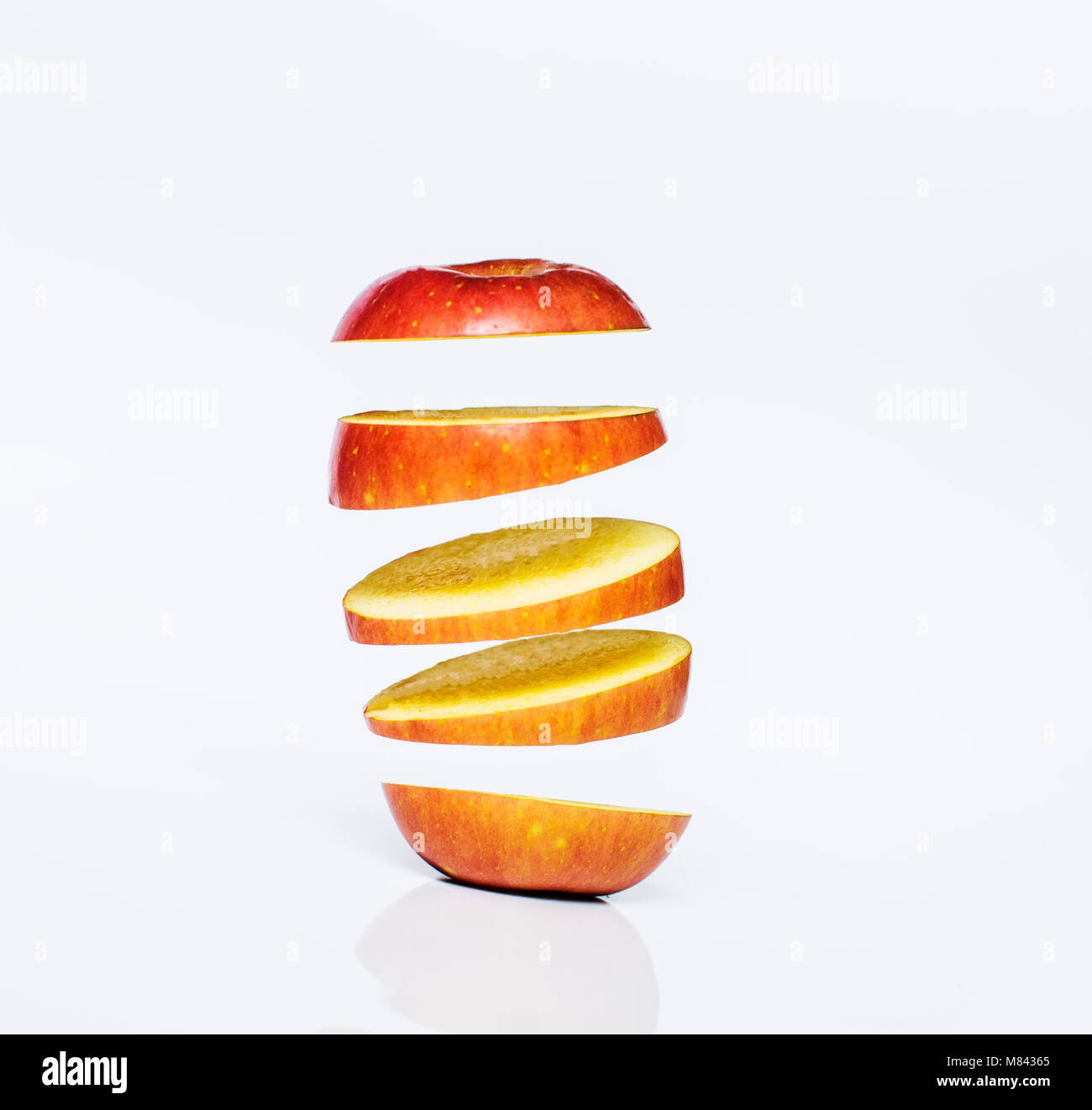 Flying slices of fruit: apple on isolated white background Stock Photo ...