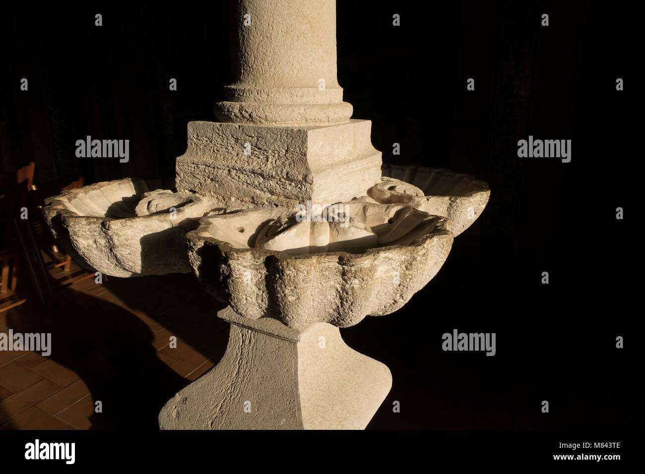 Ancient stone baptismal font Stock Photo - Alamy