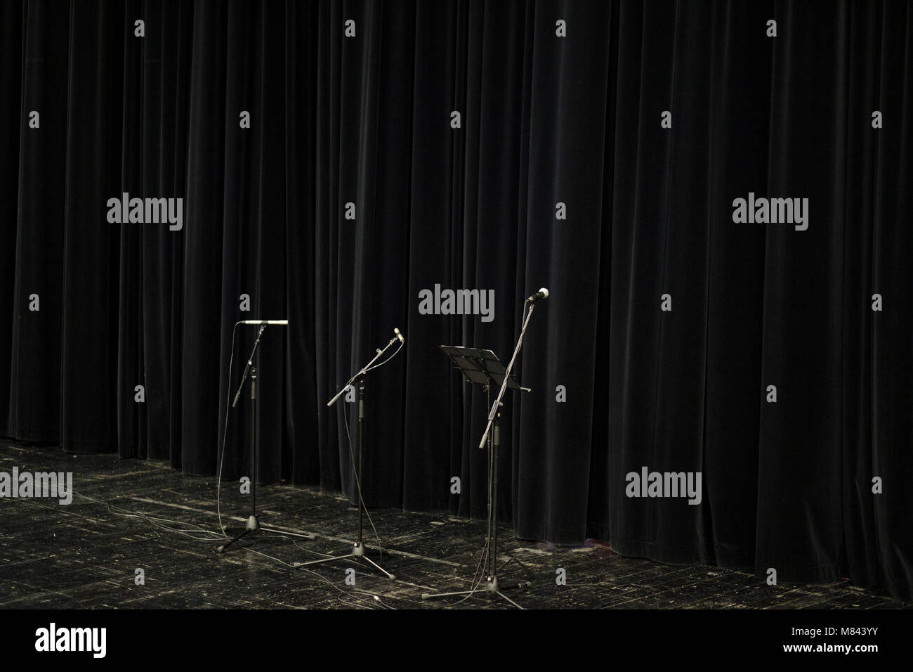 Microphones on an empty stage Stock Photo - Alamy